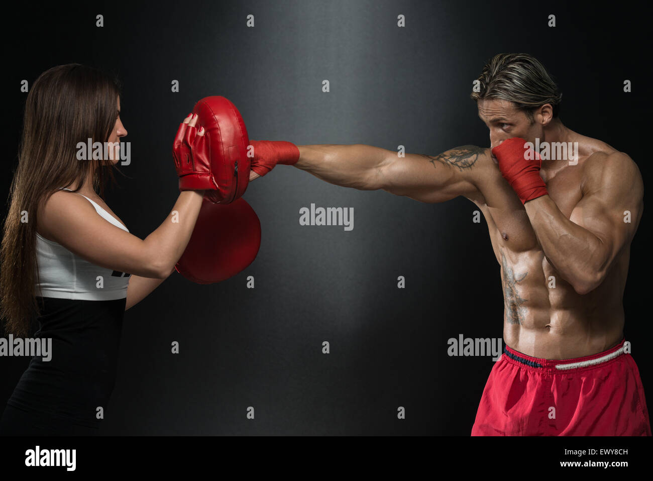 Bodybuilding Couple Posing With Boxing Gloves On Black Background Stock ...