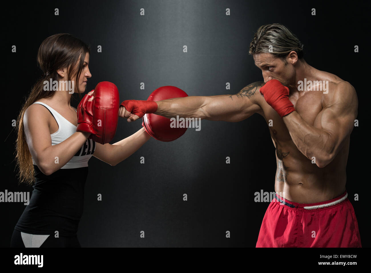 Bodybuilding Couple Posing With Boxing Gloves On Black Background Stock ...