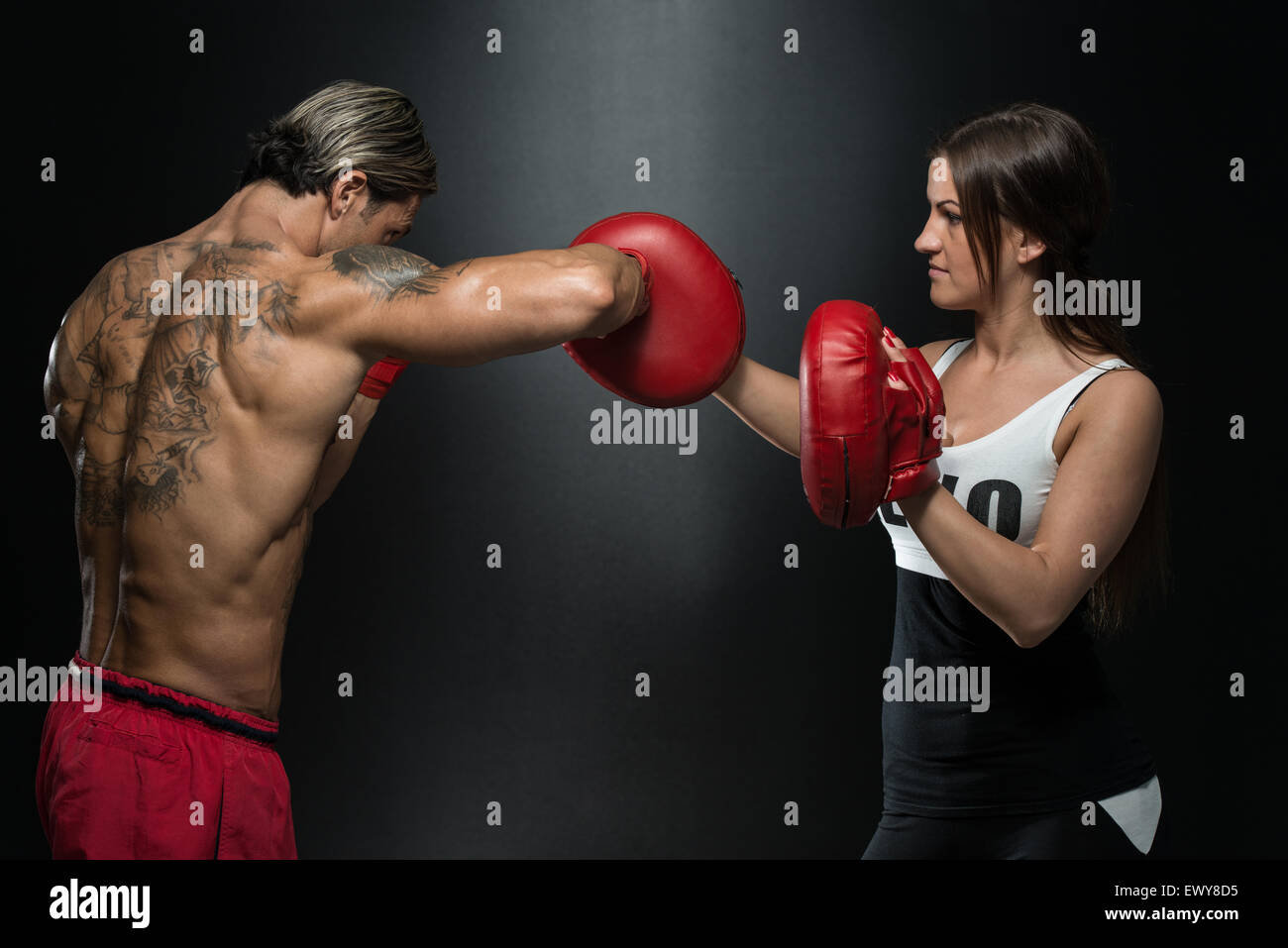 Bodybuilding Couple Posing With Boxing Gloves On Black Background Stock ...