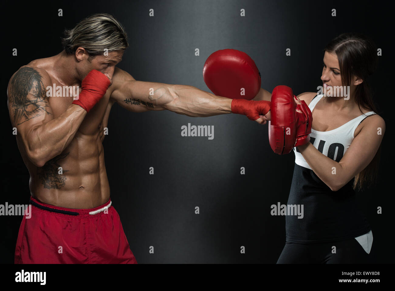Bodybuilding Couple Posing With Boxing Gloves On Black Background Stock ...
