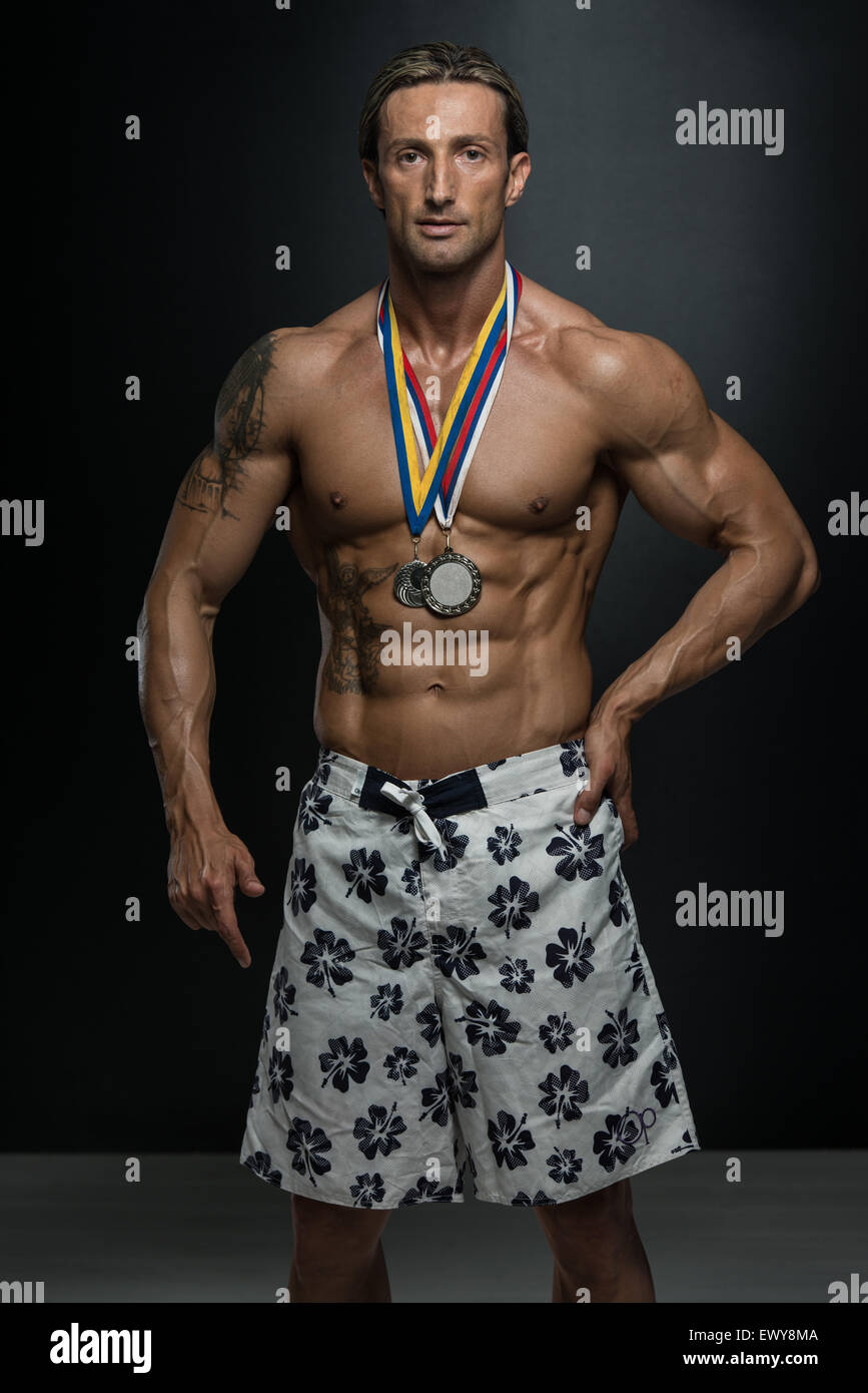 Male Fitness Competitor Showing His Winning Medal Stock Photo - Alamy