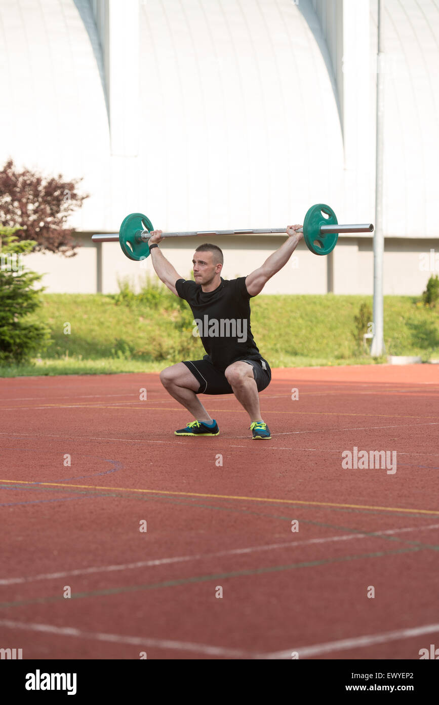 Overhead Squat Exercise Outdoor Performing By A Young Man Stock Photo ...