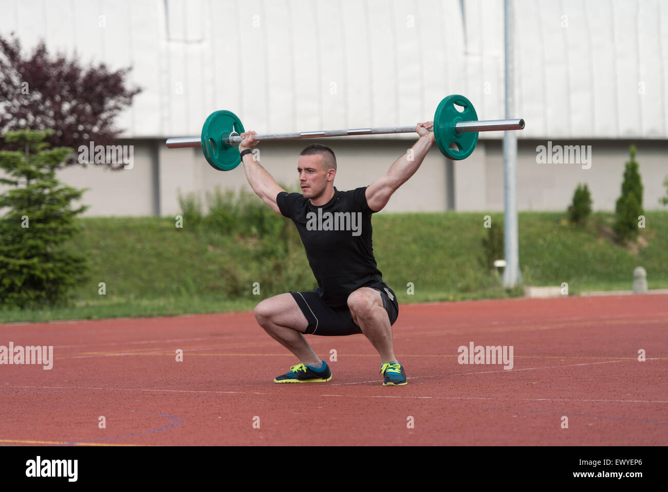 Overhead Squat Exercise Outdoor Performing By A Young Man Stock Photo ...
