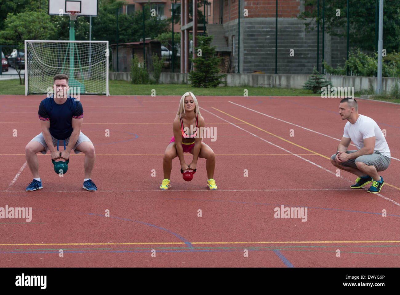 Group Of Young People Doing A Kettle Bell Exercise Outdoor With ...