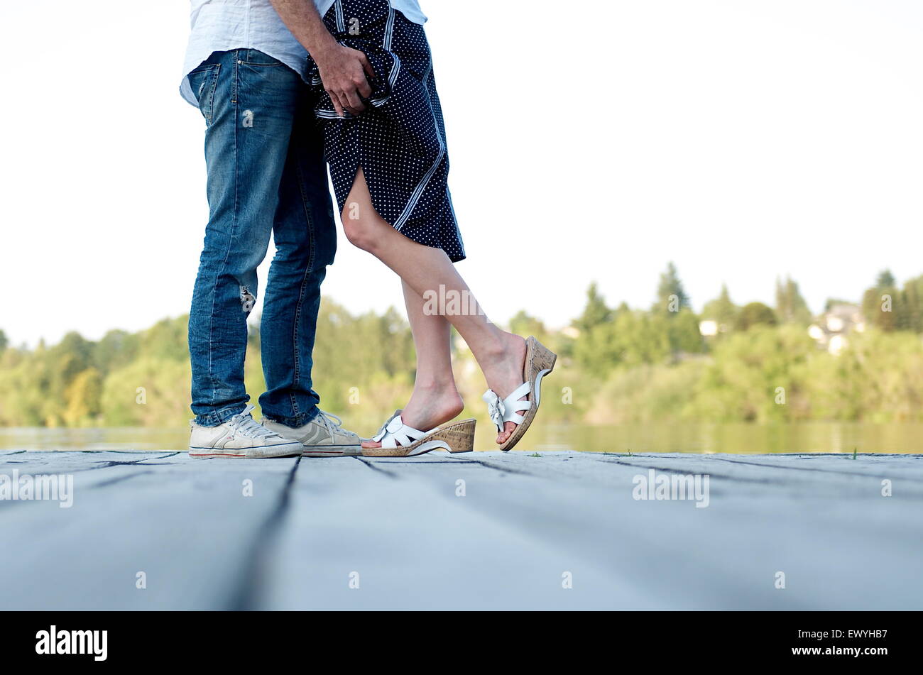 Low section of a couple kissing Stock Photo - Alamy