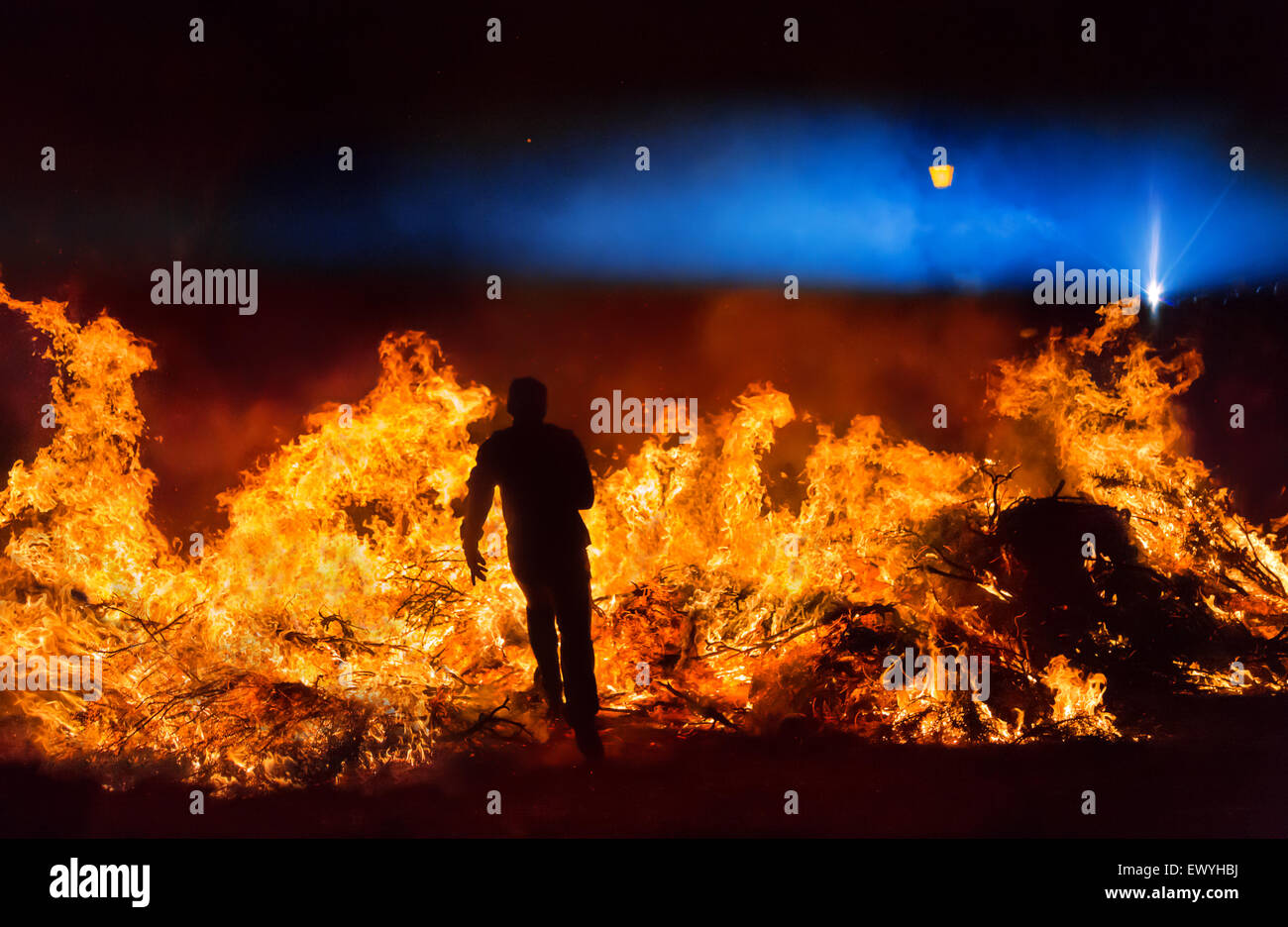 Silhouette of a man running through fire Stock Photo - Alamy