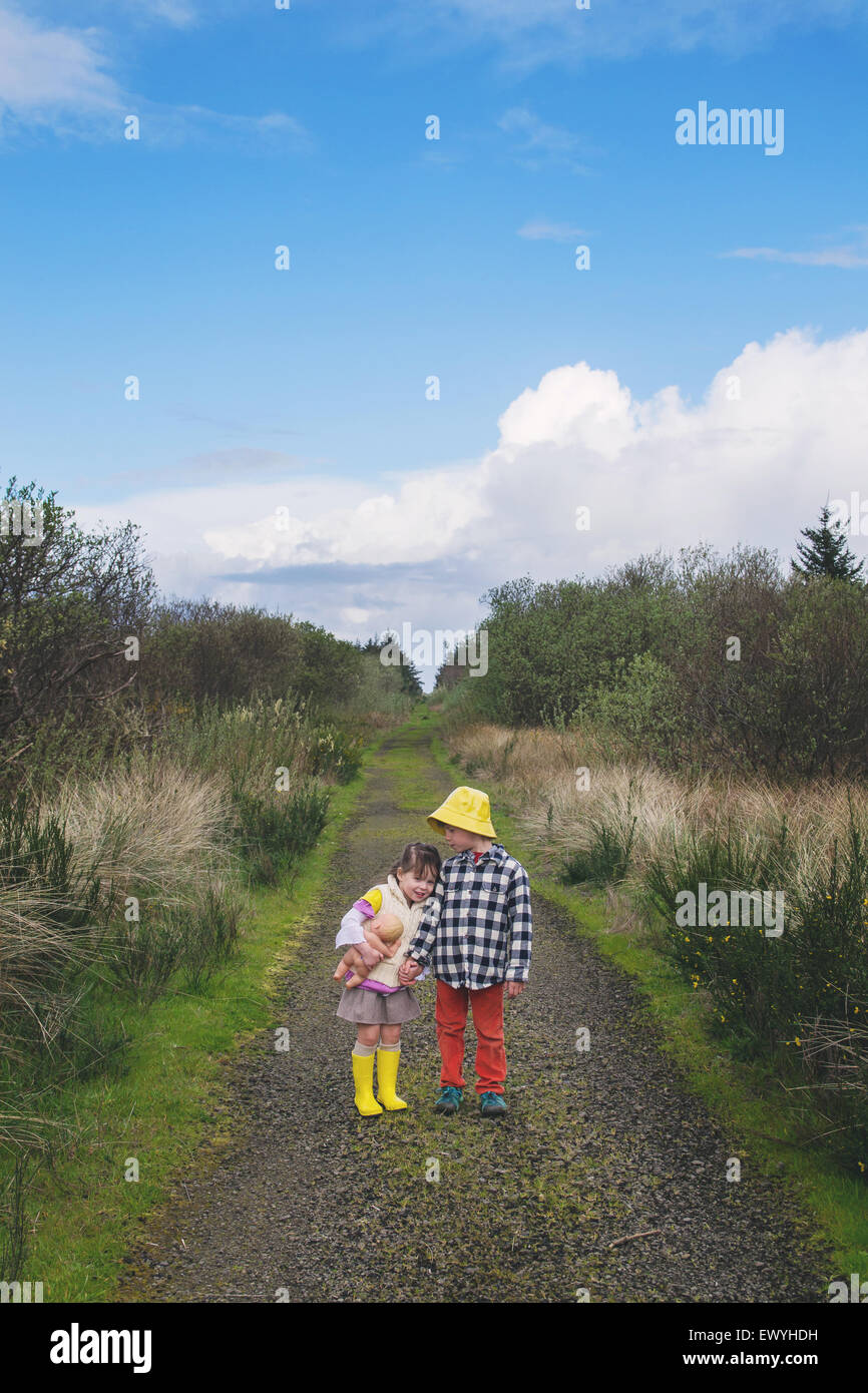 Two children standing on a path Stock Photo - Alamy