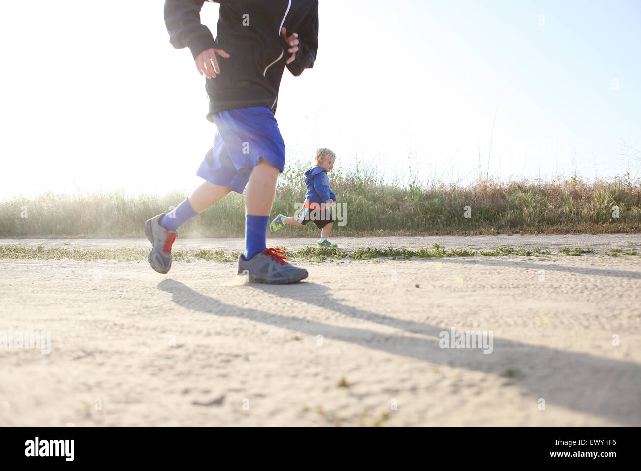 Two boys running outdoors Stock Photo - Alamy