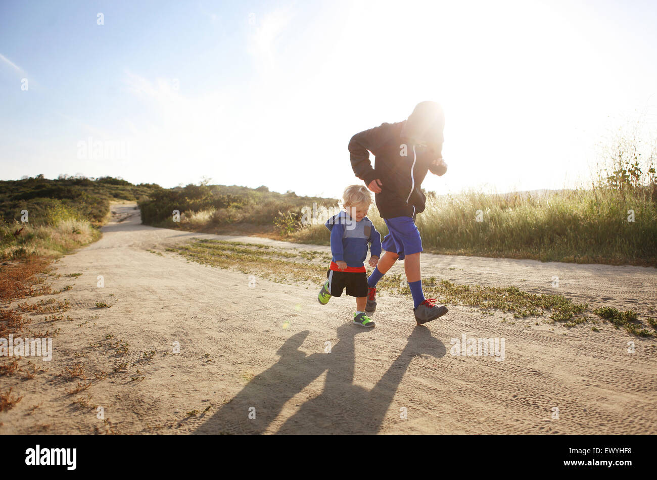 Two boys running outdoors Stock Photo - Alamy