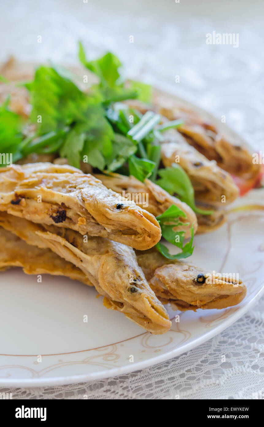 Fried river fish with garlic and pepper Stock Photo - Alamy
