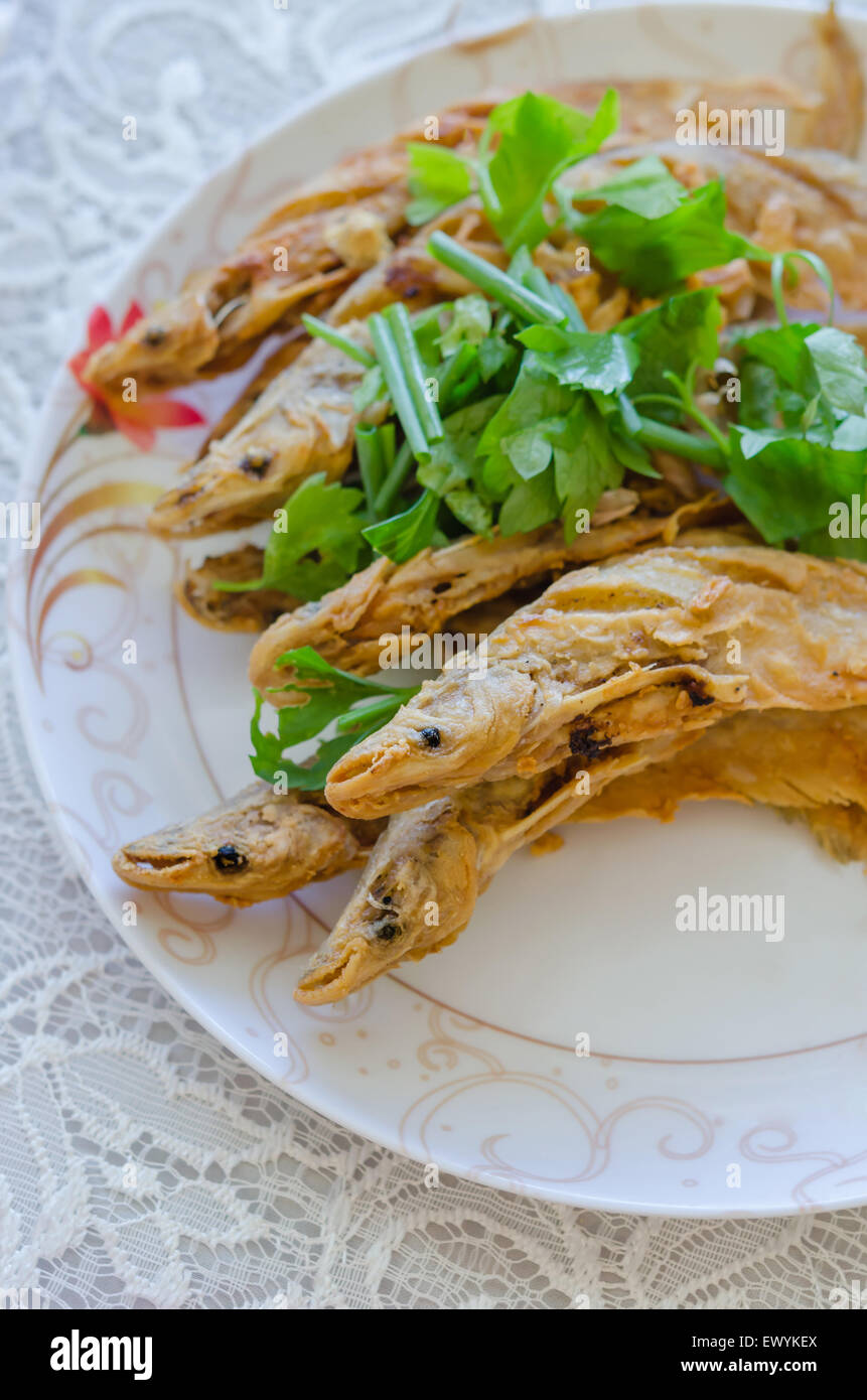 Fried river fish with garlic and pepper Stock Photo - Alamy