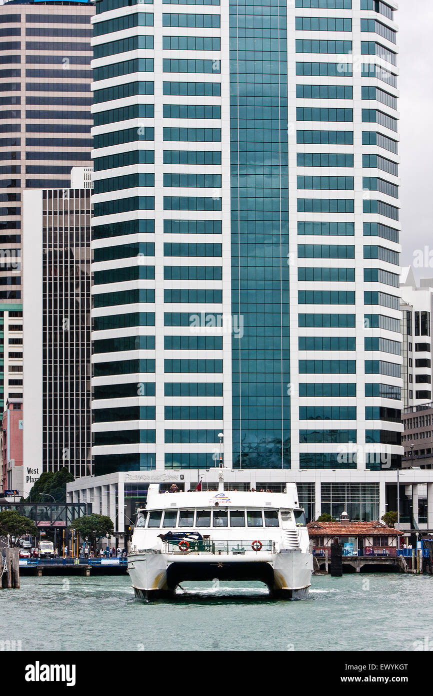 Ferry departing Ferry Terminal and office tower block of CBD Auckland ...