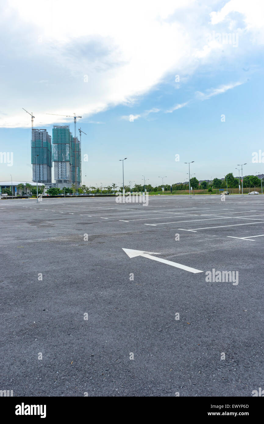 Empty parking lot with construction background Stock Photo - Alamy
