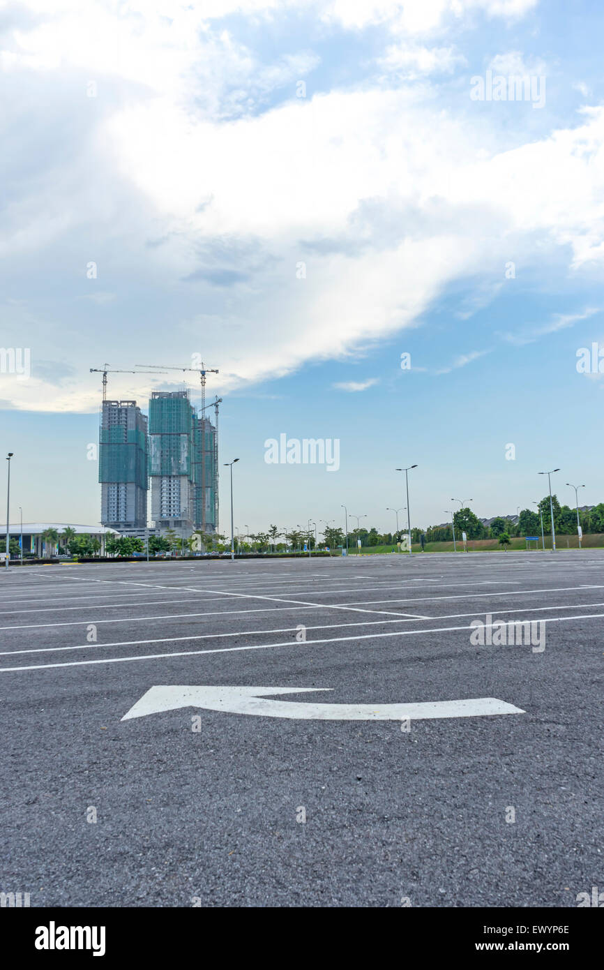 Empty parking lot with construction background Stock Photo - Alamy
