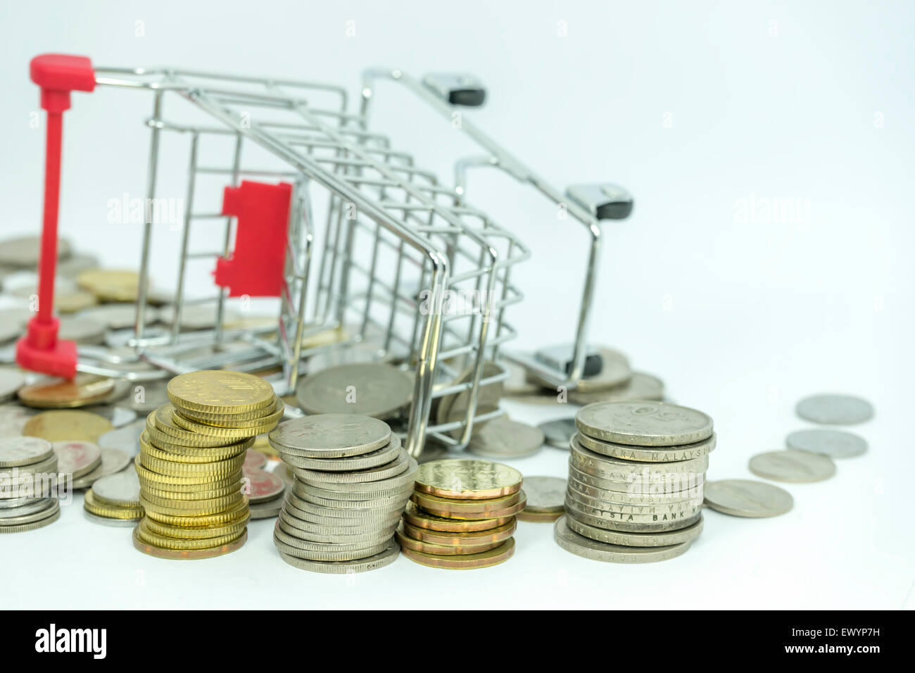Coins and trolley with white background Stock Photo - Alamy