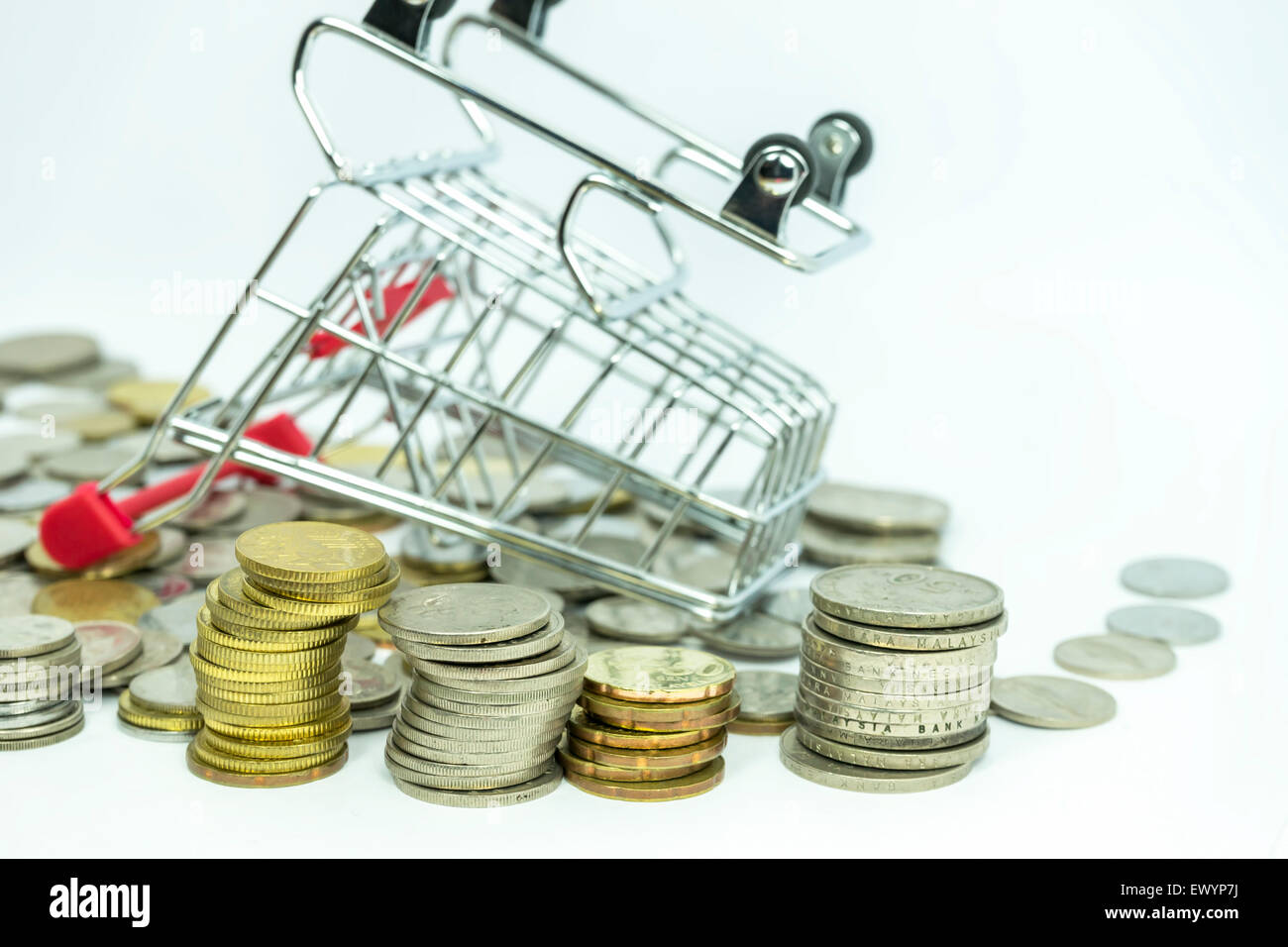 Coins and trolley with white background Stock Photo - Alamy