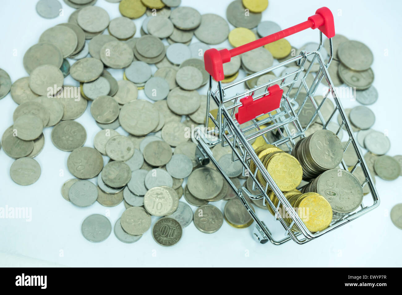 Coins and trolley with white background Stock Photo - Alamy