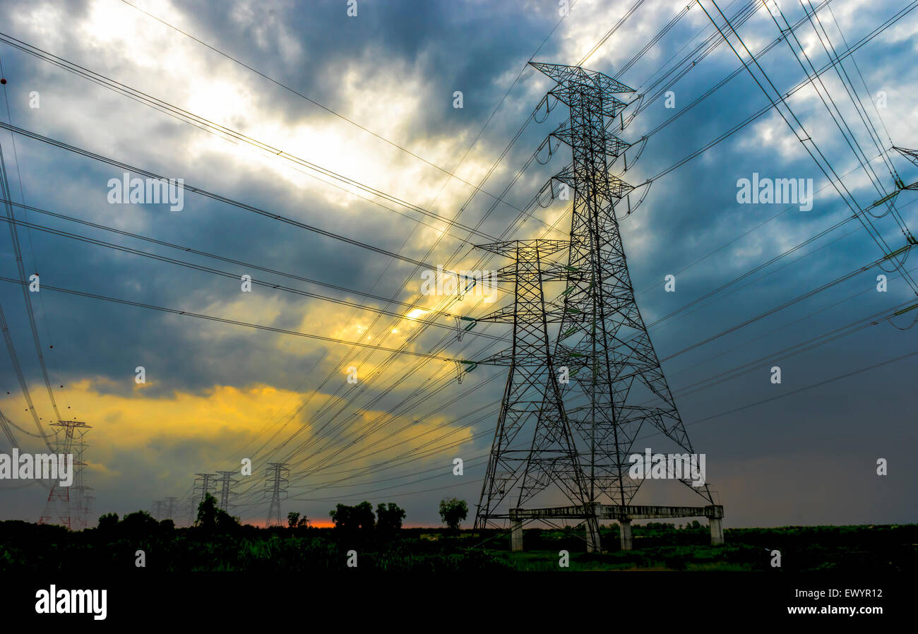 Electricity pylons and cable lines during sunset Stock Photo - Alamy