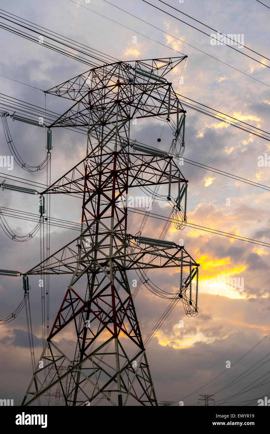 Electricity pylons and cable lines during sunset Stock Photo - Alamy