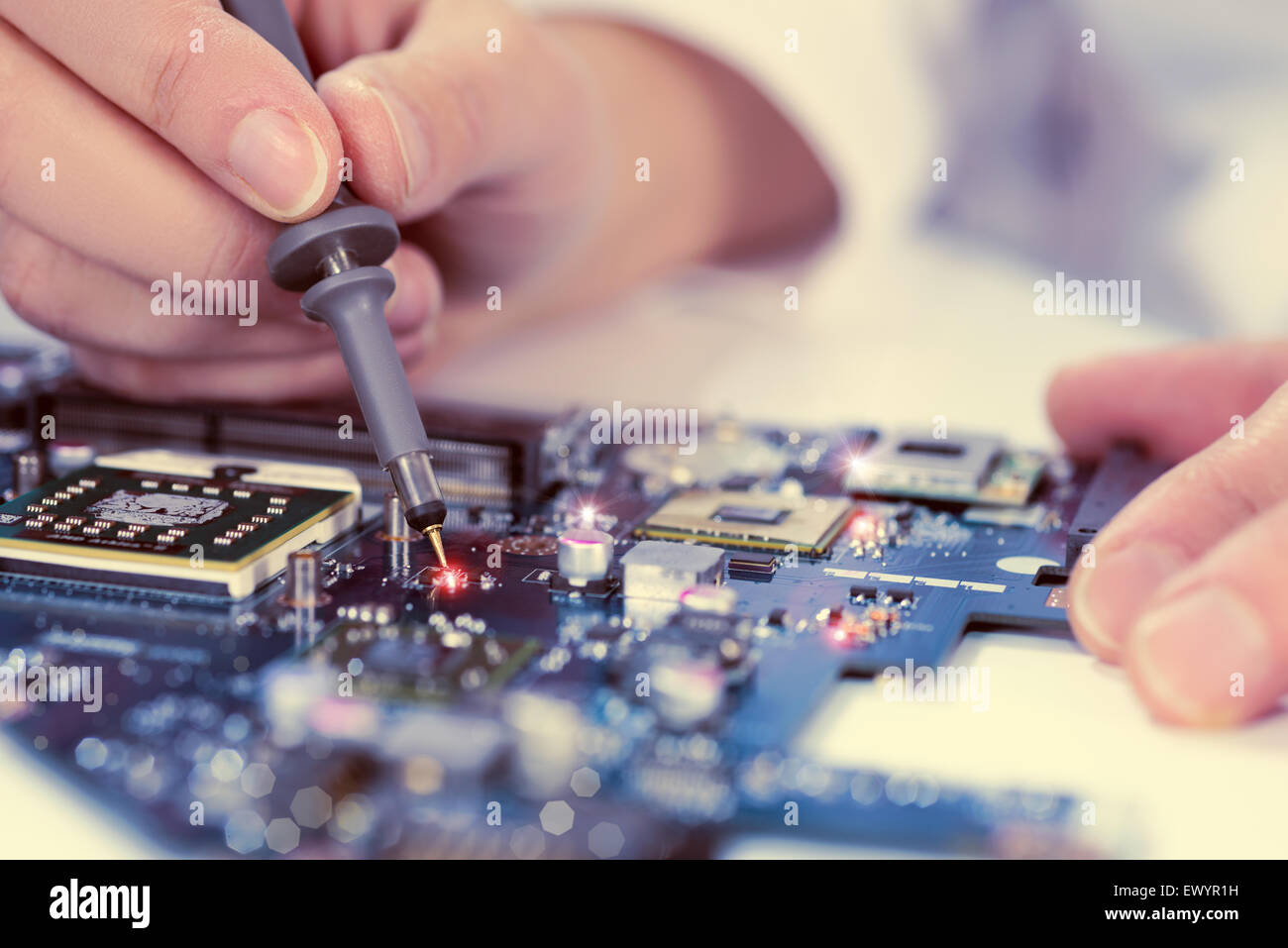 Technological background with closeup on tester checking motherboard ...