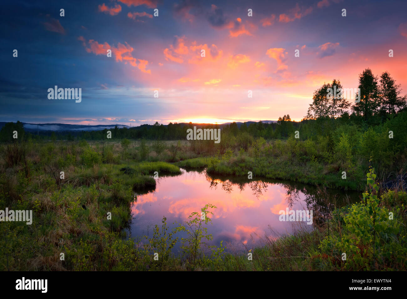 Sunrise reflection in a lake Stock Photo - Alamy