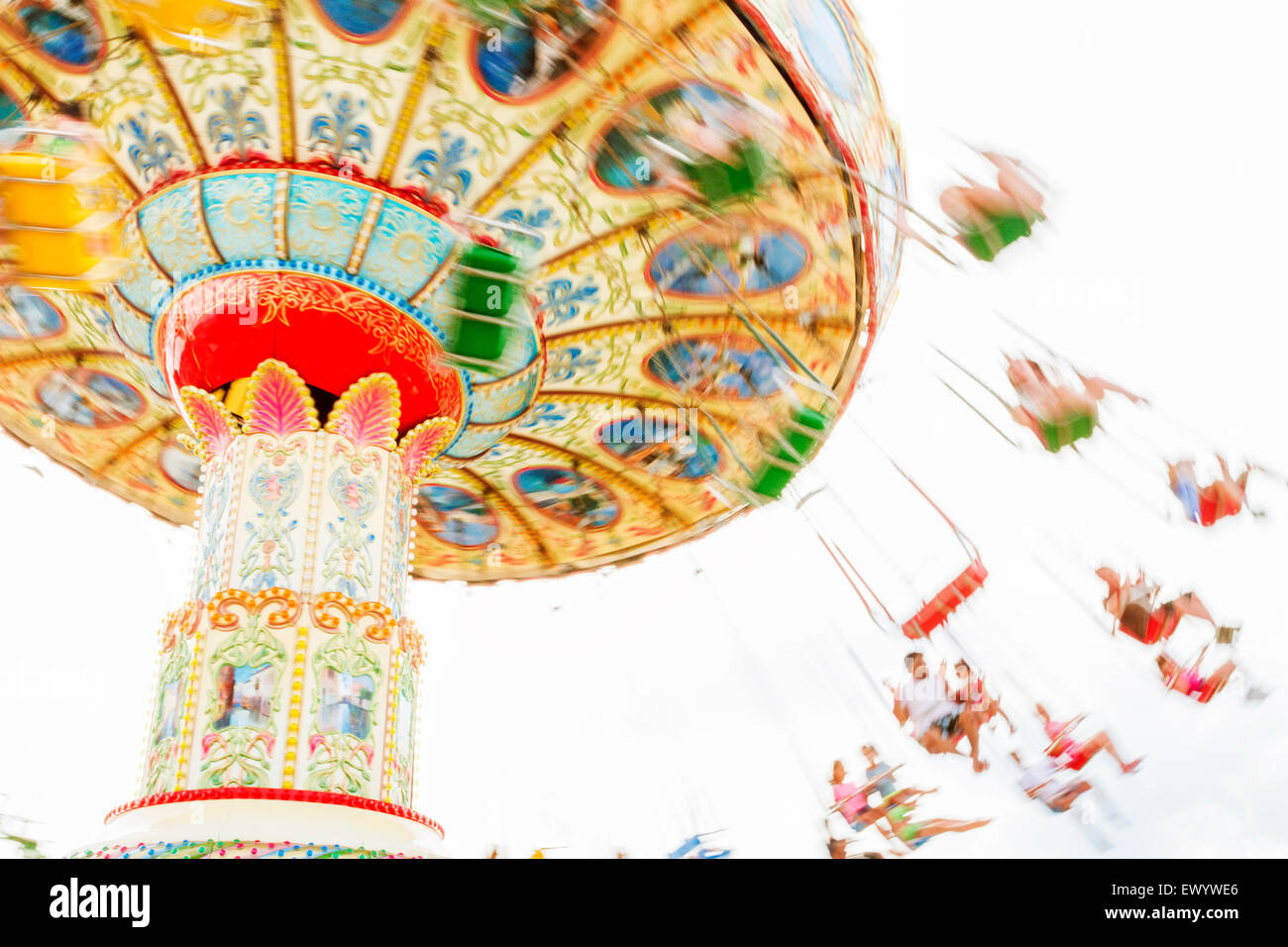 Children riding a colorful merry-go-round at the county fair Stock ...
