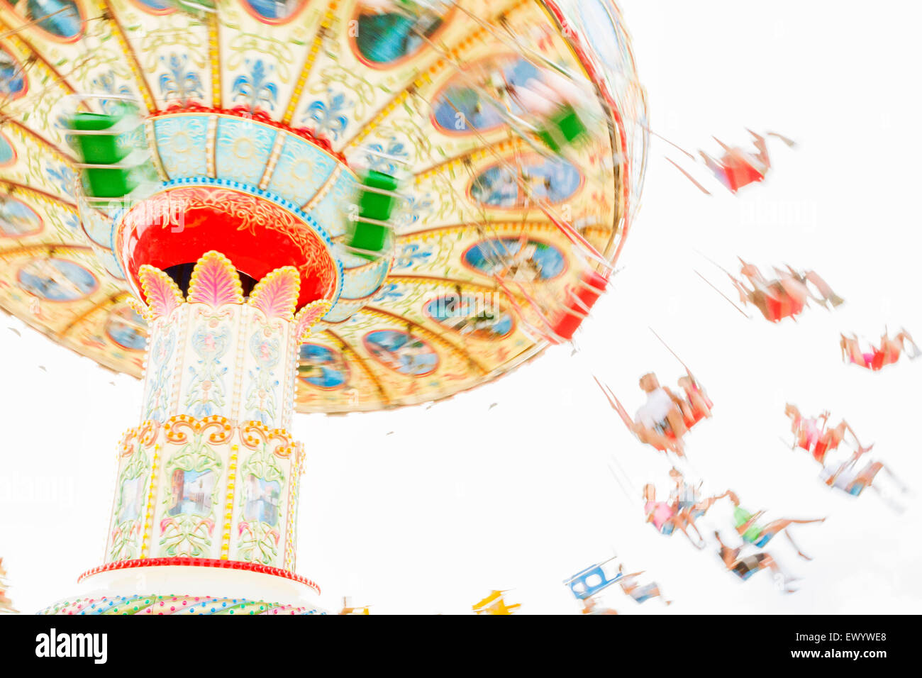 Children riding a colorful merry-go-round at the county fair Stock ...