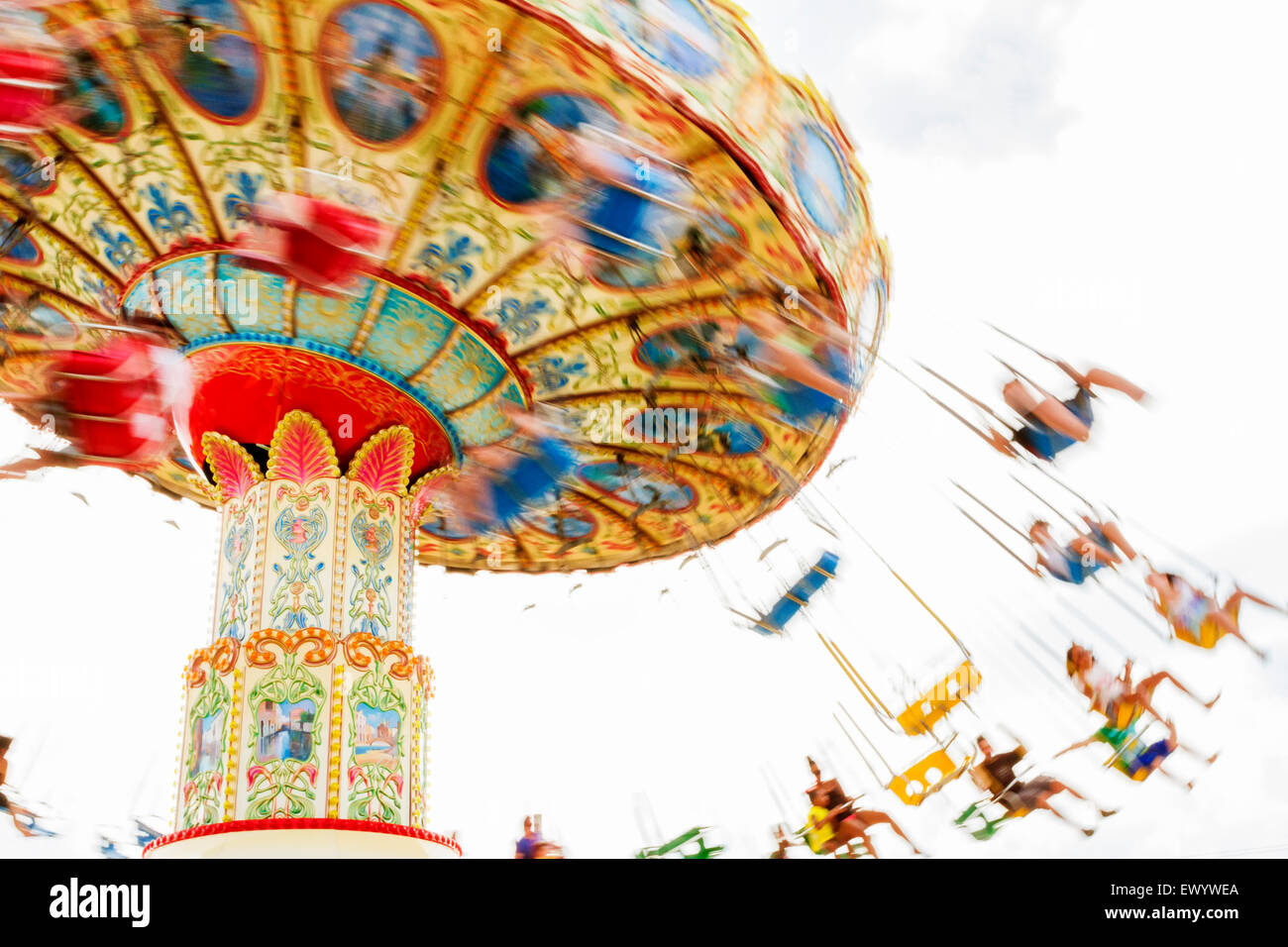 Children riding a colorful merry-go-round at the county fair Stock ...