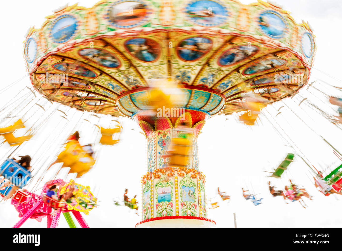 Children riding a colorful merry-go-round at the county fair Stock ...