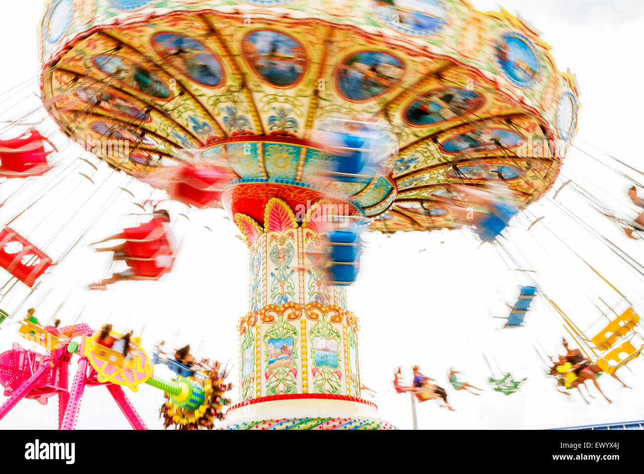 Children riding a colorful merry-go-round at the county fair Stock ...