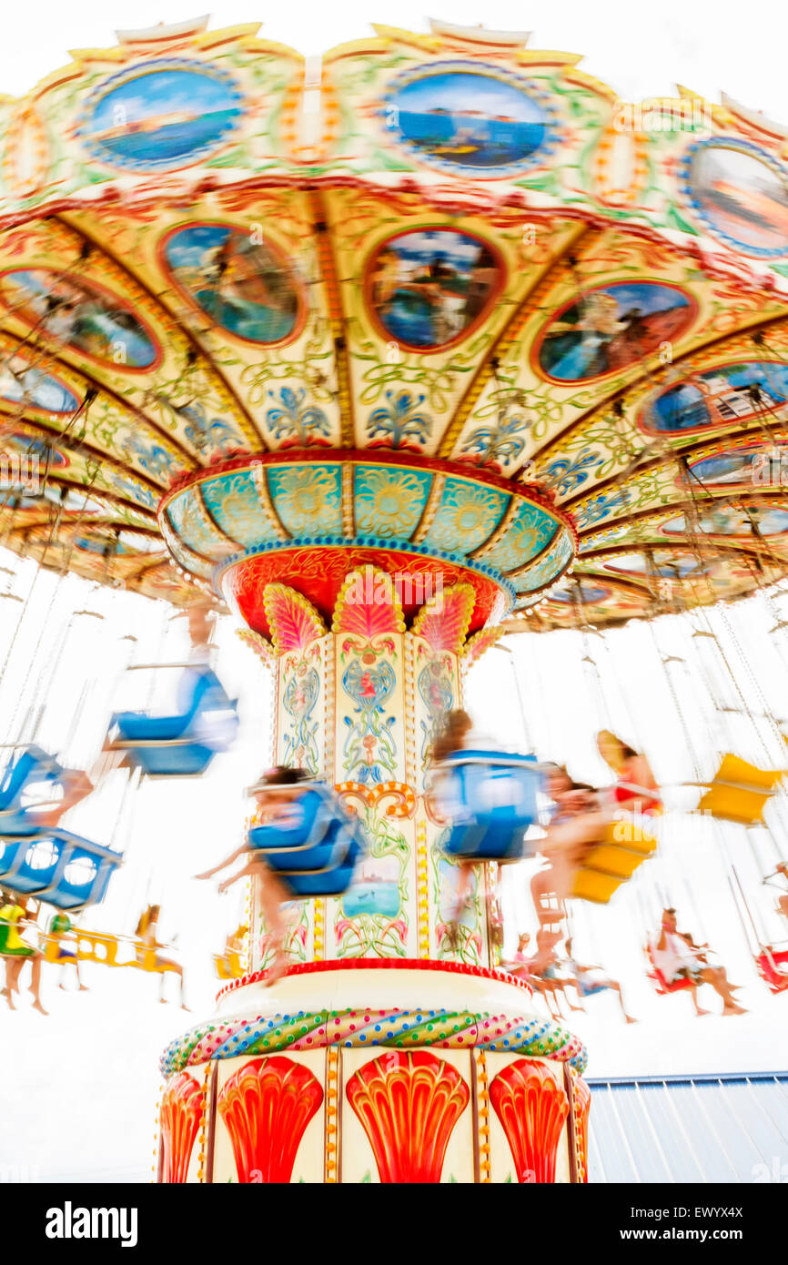 Children riding a colorful merry-go-round at the county fair Stock ...