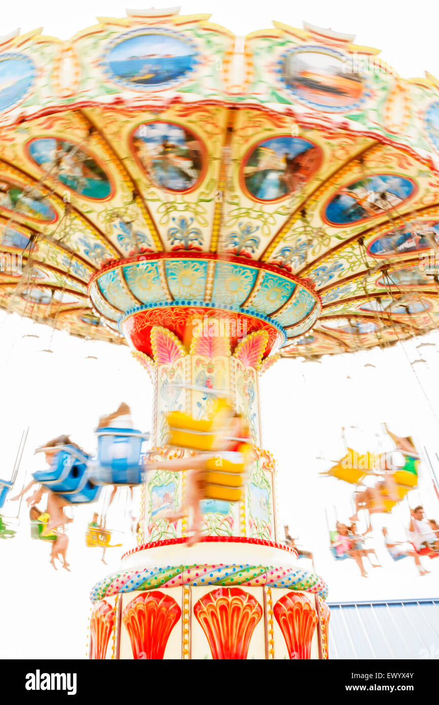 Children riding a colorful merry-go-round at the county fair Stock ...