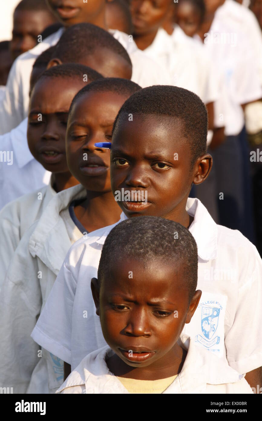 Group of students in schoolyard during morning assembly, Kasongo-Lunda ...