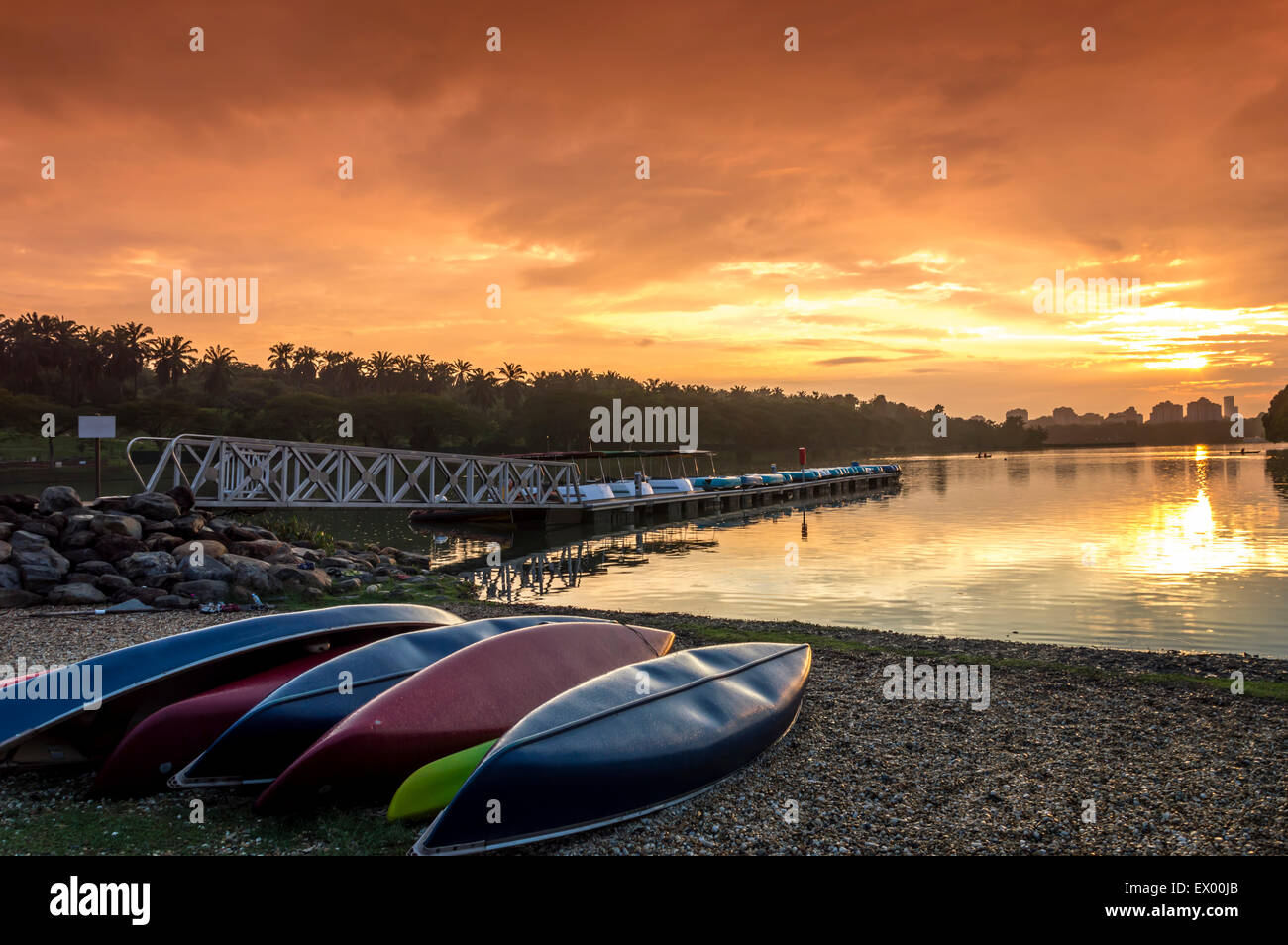 Canoe with sunset background Stock Photo - Alamy