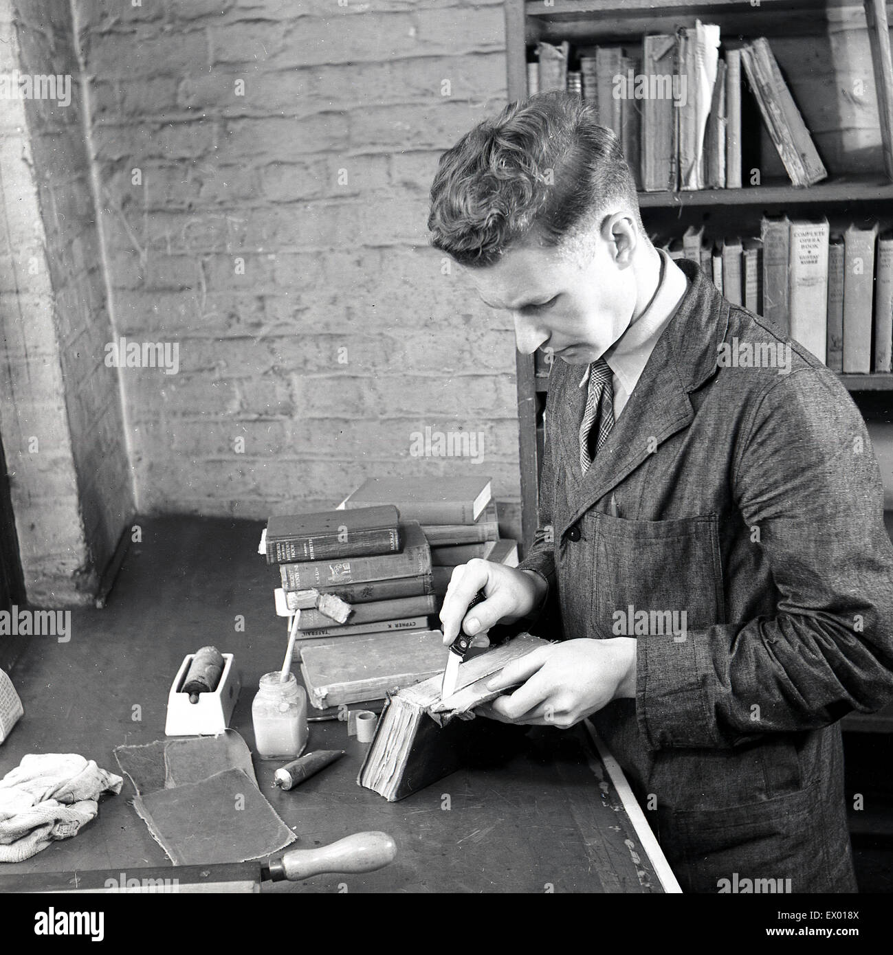 Historical, 1950s, picture shows a male bookbinder working at his bench ...