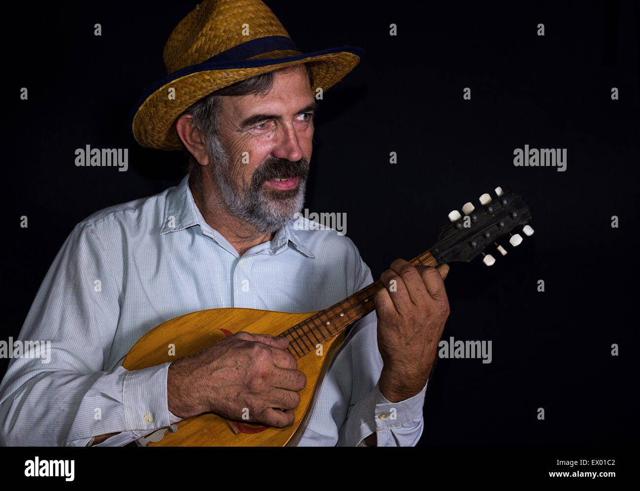 Portrait (low key) of an old country man with mandolin Stock Photo - Alamy