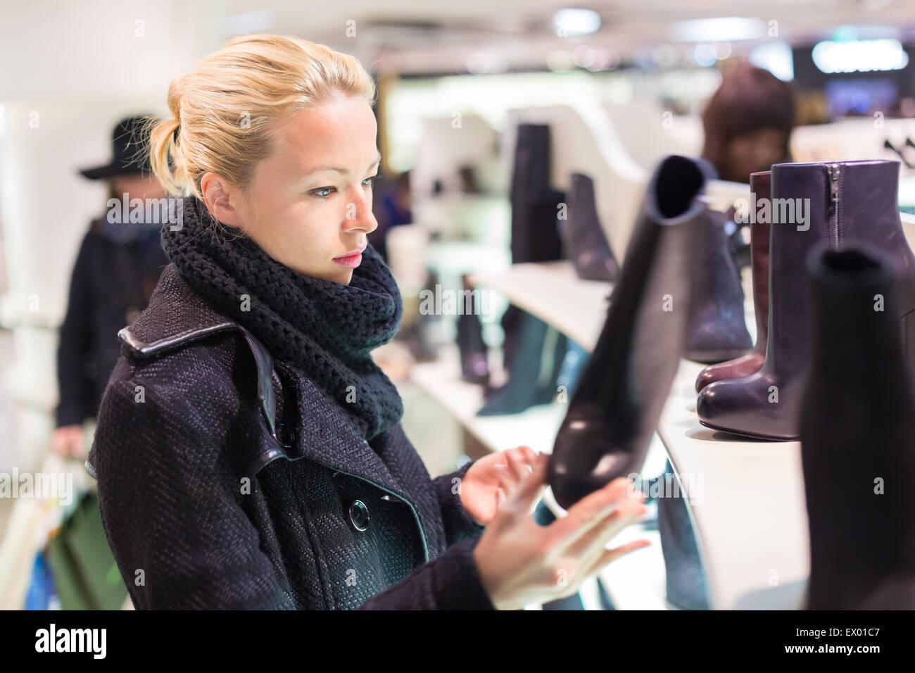 Beautiful woman shopping in shoe store Stock Photo - Alamy