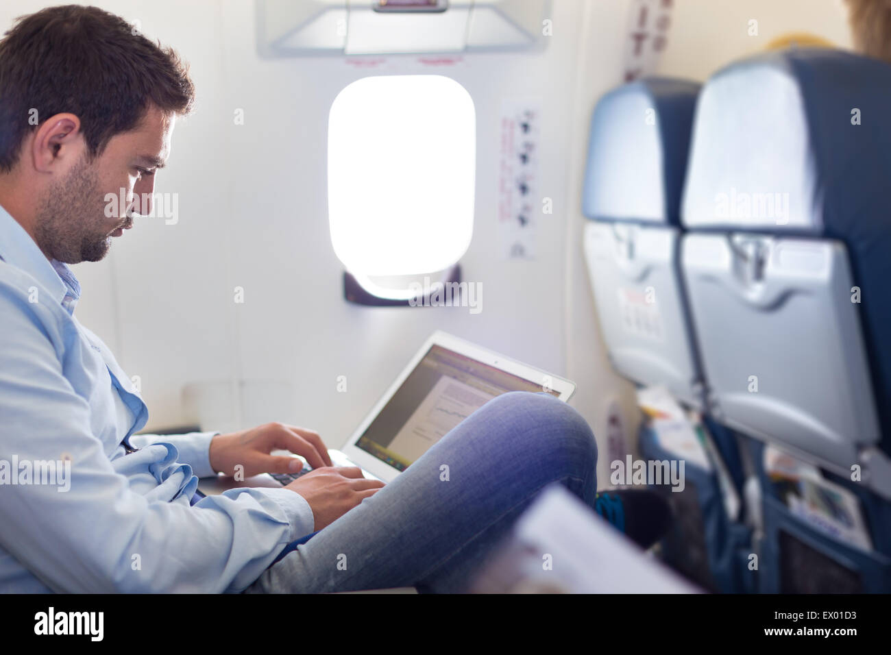 Working in an airplane hi-res stock photography and images - Alamy