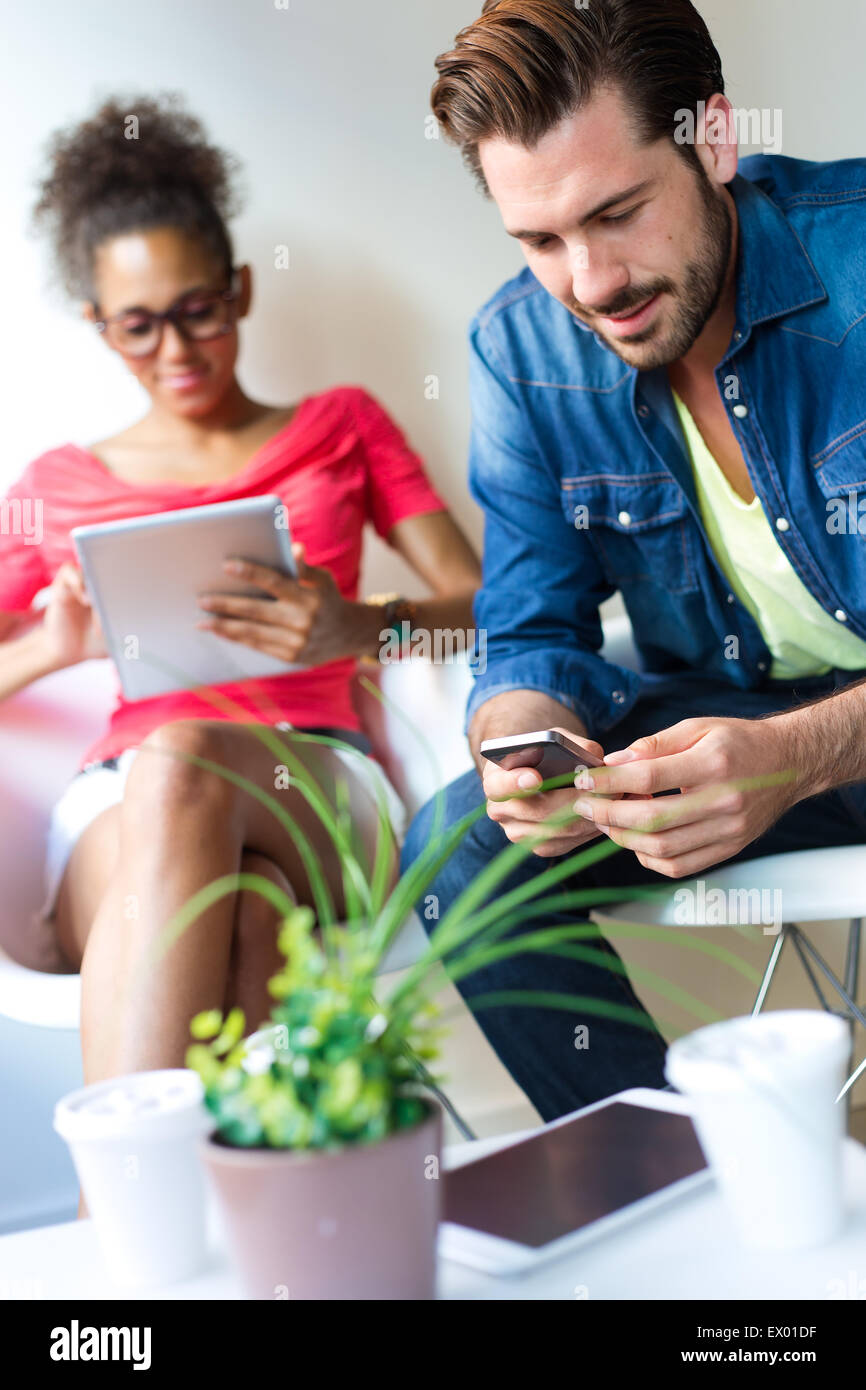 Group of people all using electronics hi-res stock photography and ...