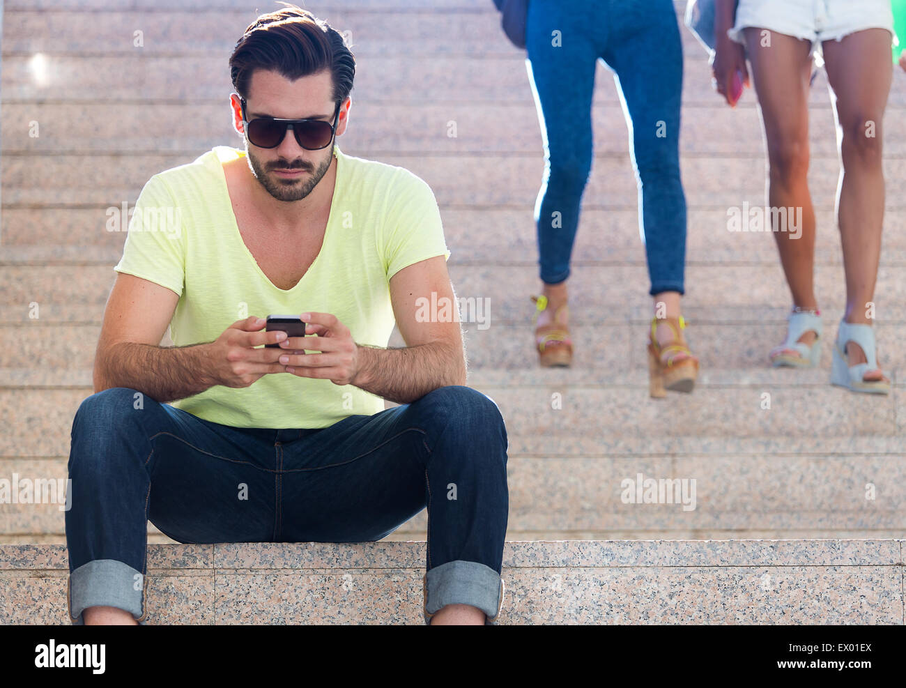 Portrait of young man using his mobile phone in the street Stock Photo ...