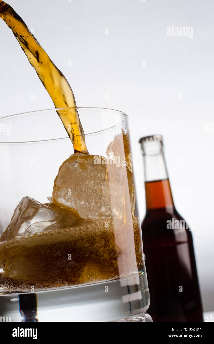 Pouring glass of cold cola Stock Photo - Alamy