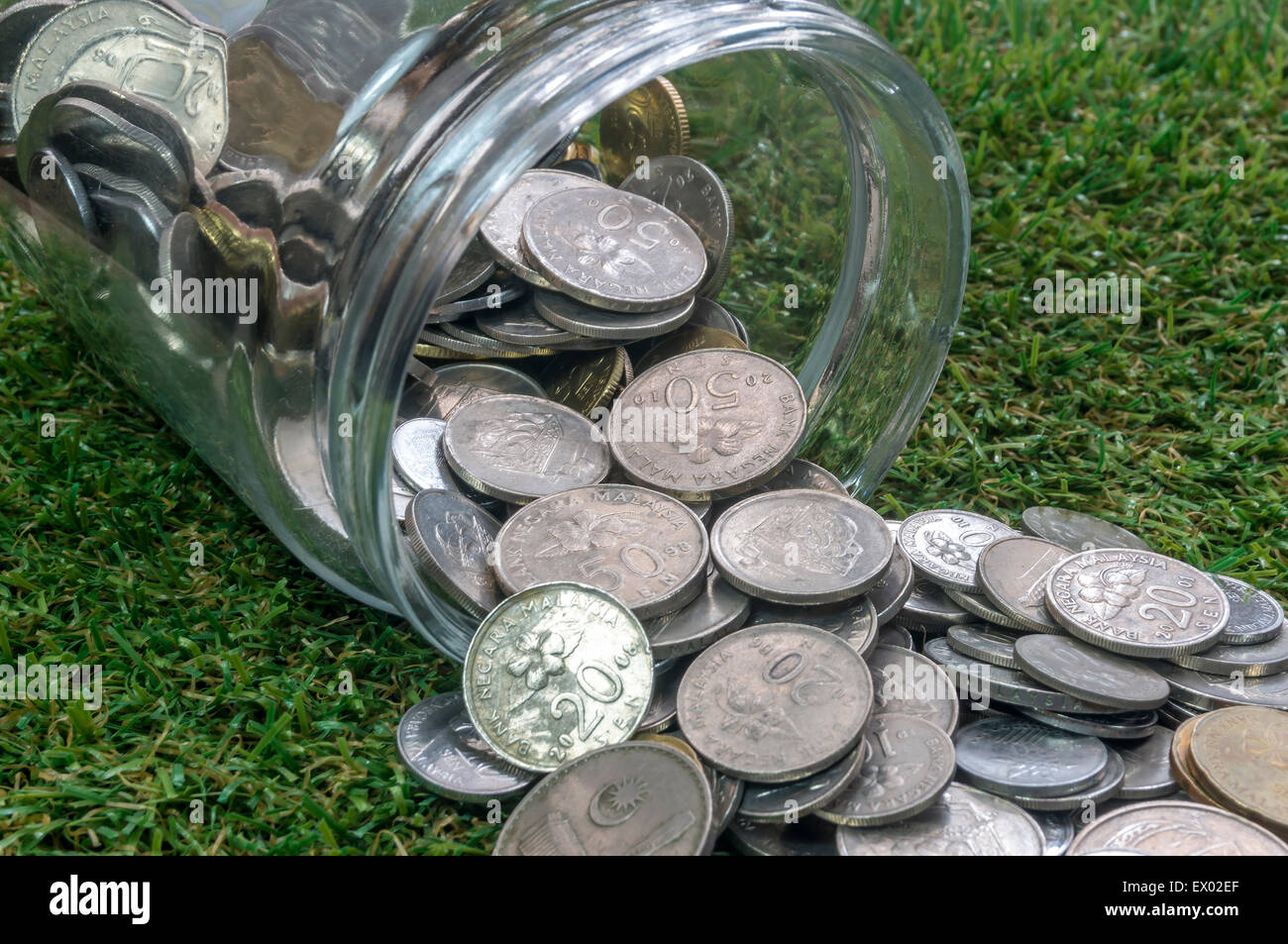coins inside glass jar Stock Photo - Alamy