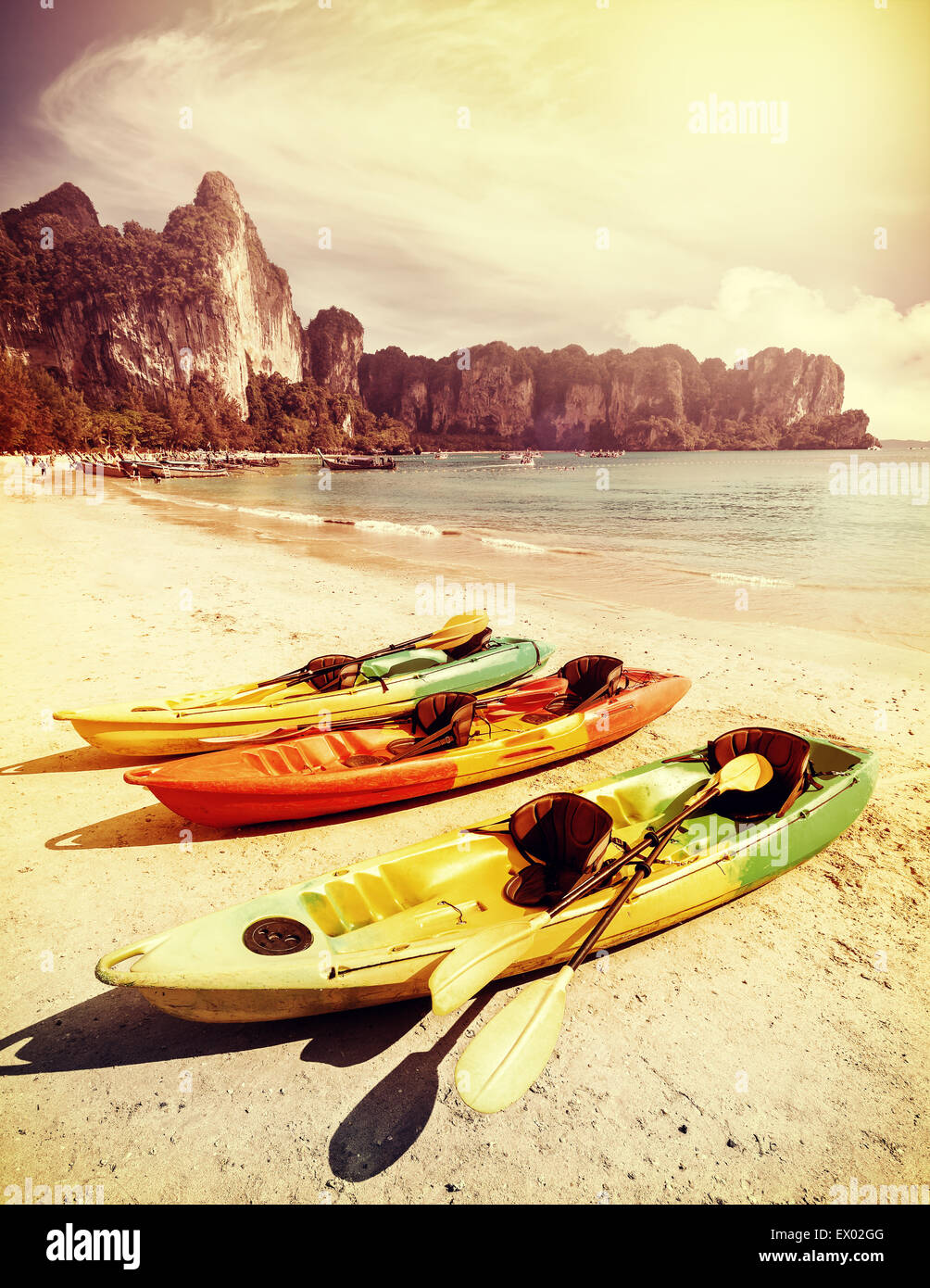 Retro toned kayaks on a tropical beach. Active holidays background ...