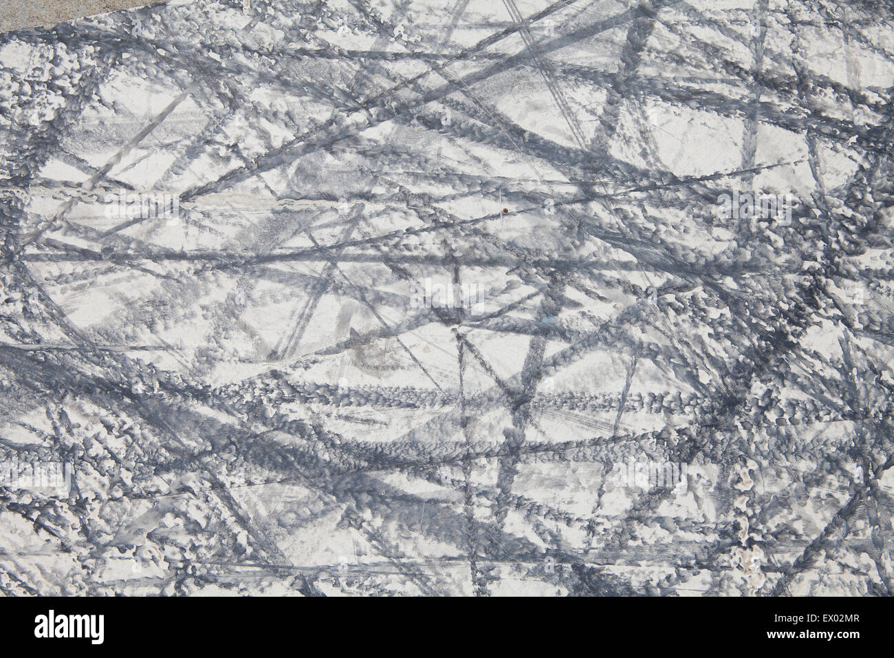Black rubber tyre marks left on the carpark markings, used as a pitch ...