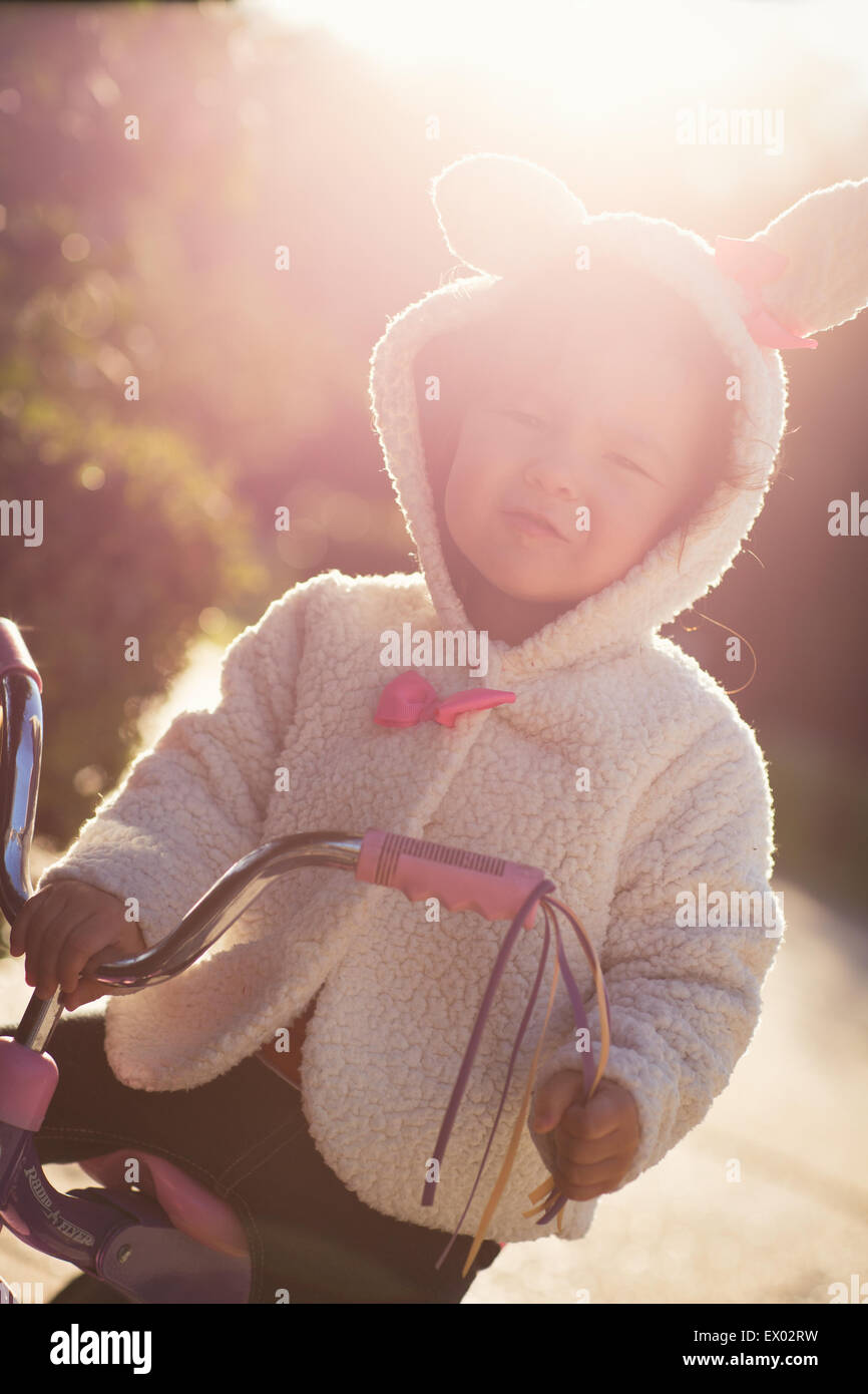 Little girl learning to ride tricycle Stock Photo - Alamy