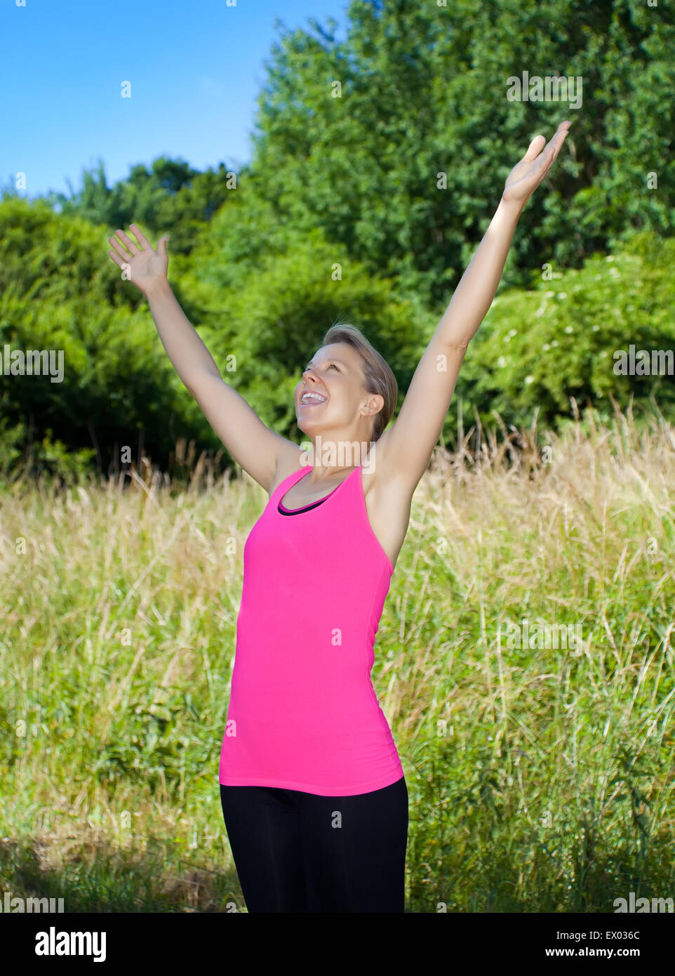 beautiful young woman with raised arms Stock Photo - Alamy