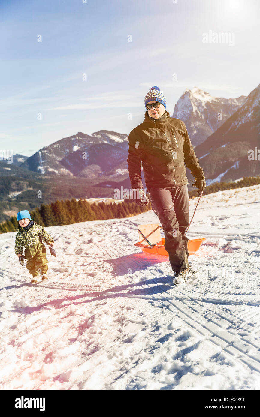 Man pulling sled on snow, Achenkirch, Tirol, Austria Stock Photo - Alamy