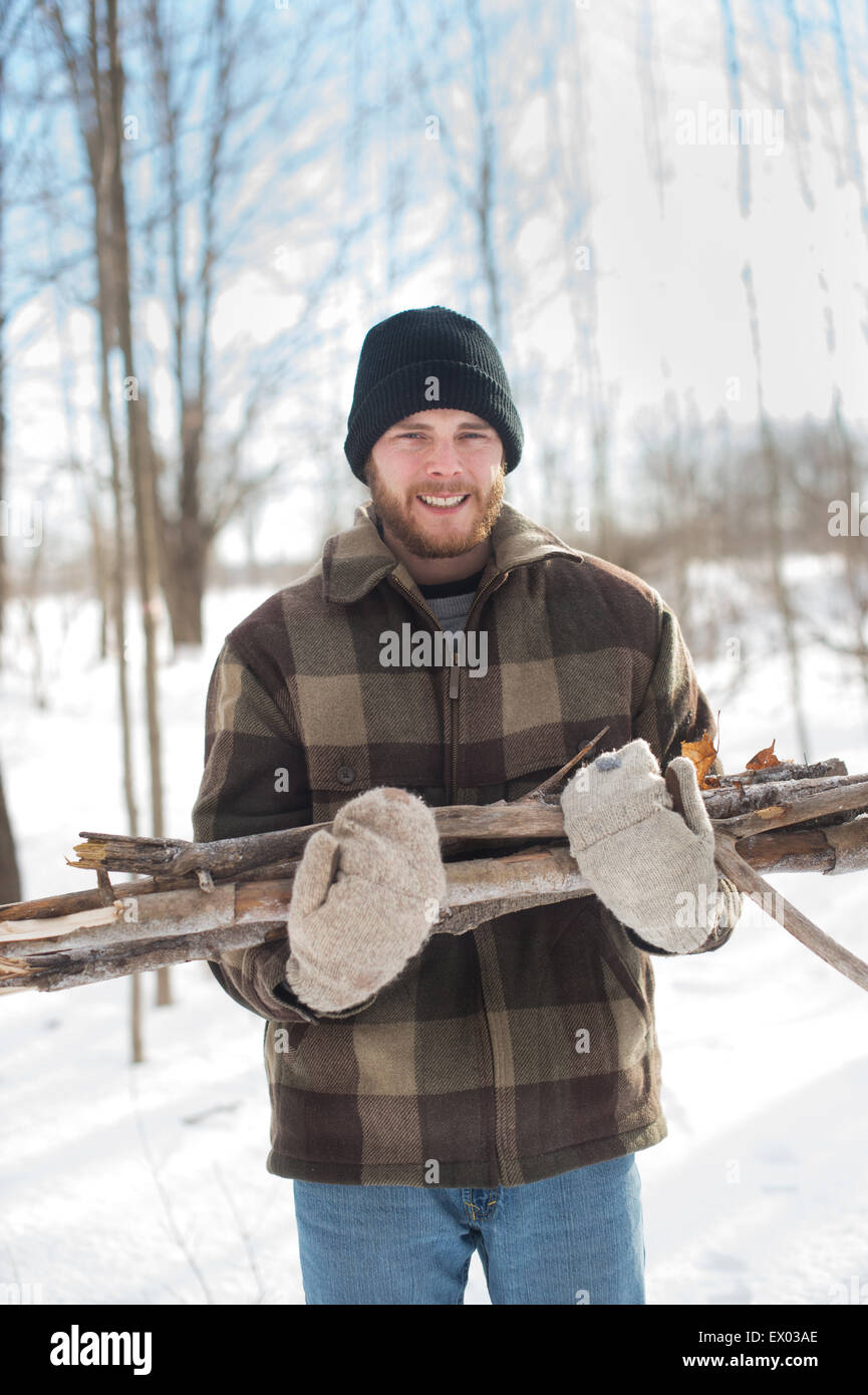 Man gathering wood in forest, Young's Point, Ontario, Canada Stock ...