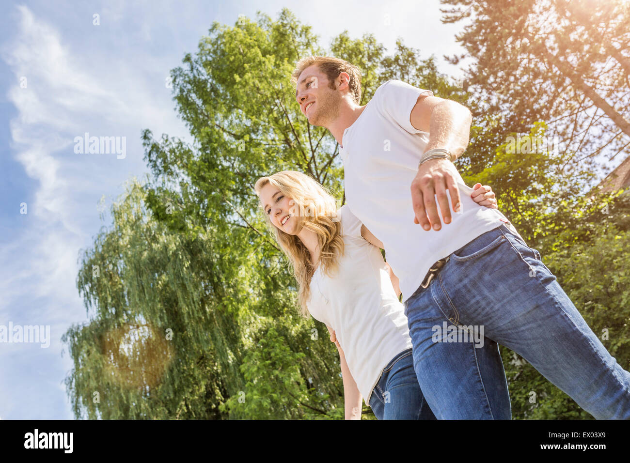Couple walking through forest, low angle view Stock Photo - Alamy