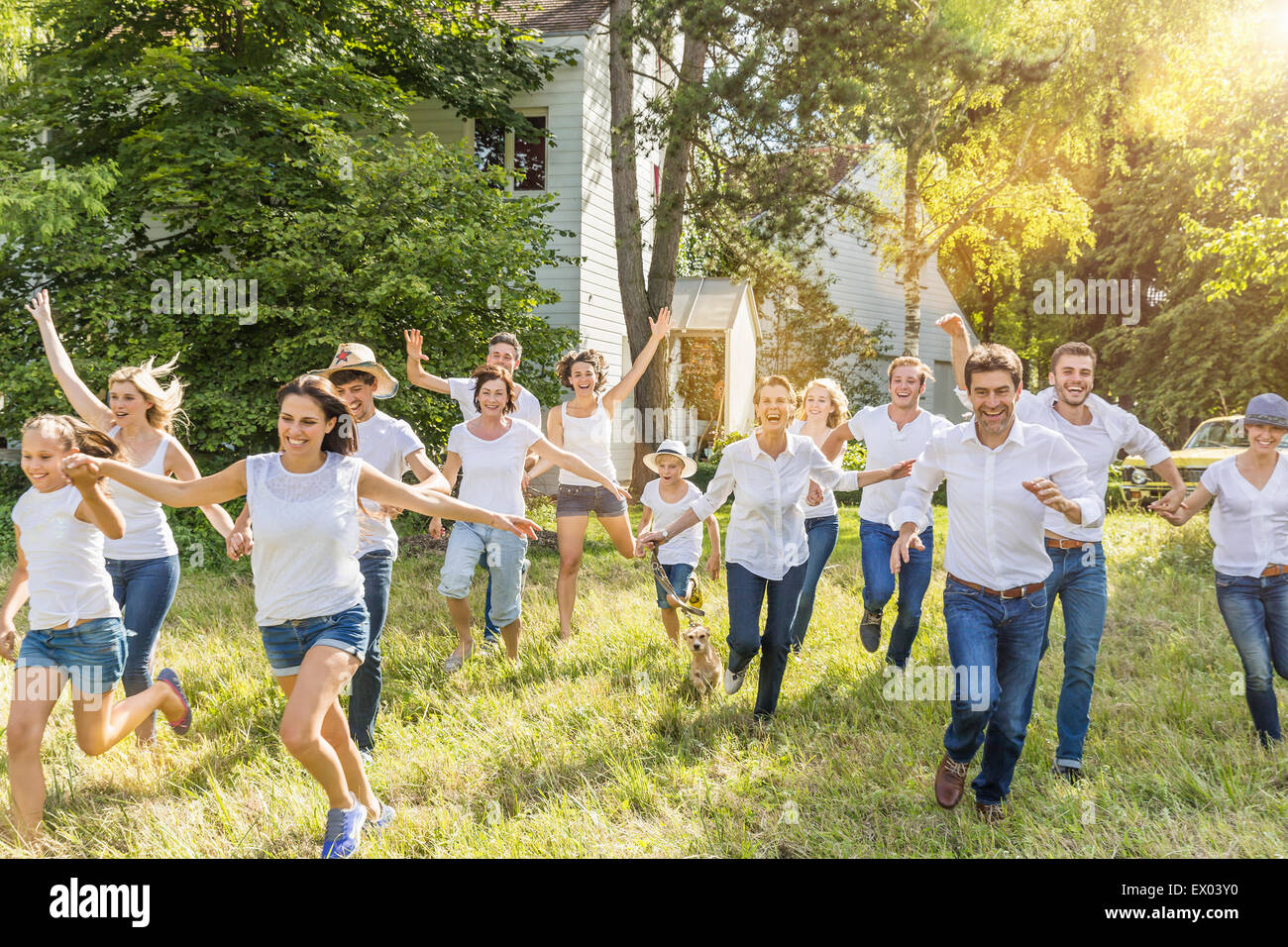 Group of people running through forest Stock Photo - Alamy